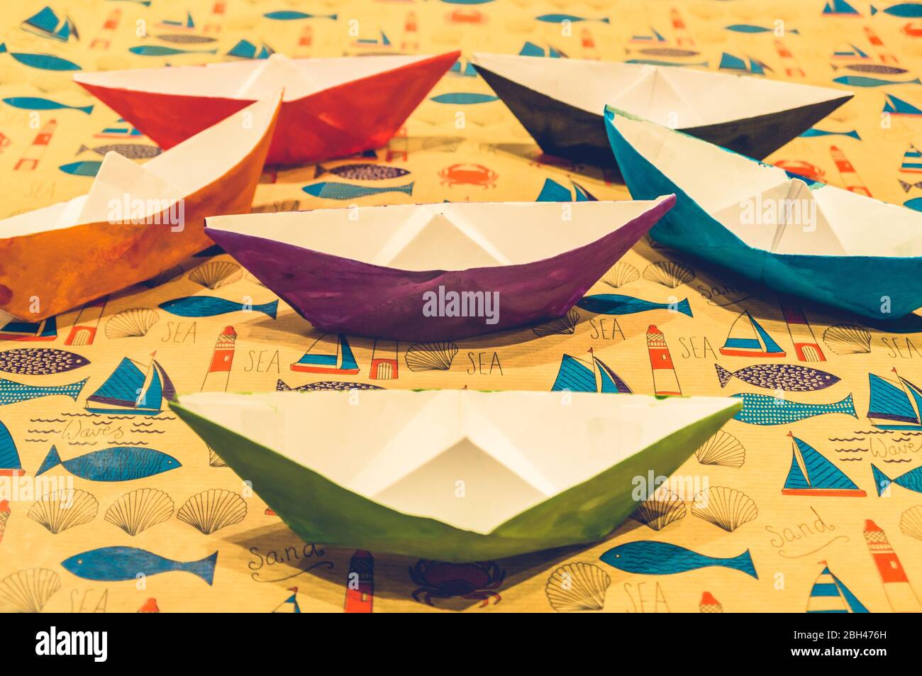 Colorful water color painted paper boats on cartoon background ...
