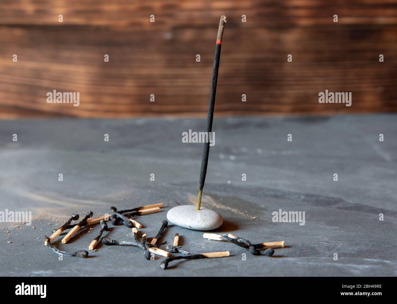 One incense stick set in a stone Stock Photo - Alamy