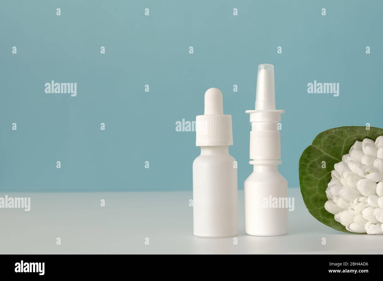 Spray for nose, dropper and a bouquet of snowdrops. Allergy. Two white ...
