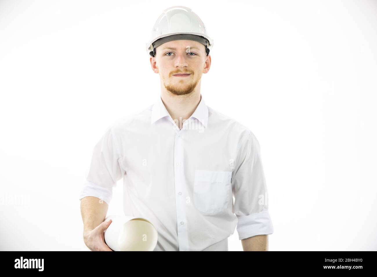 confident and positive engineer holds rolled-up drawing looks at camera ...