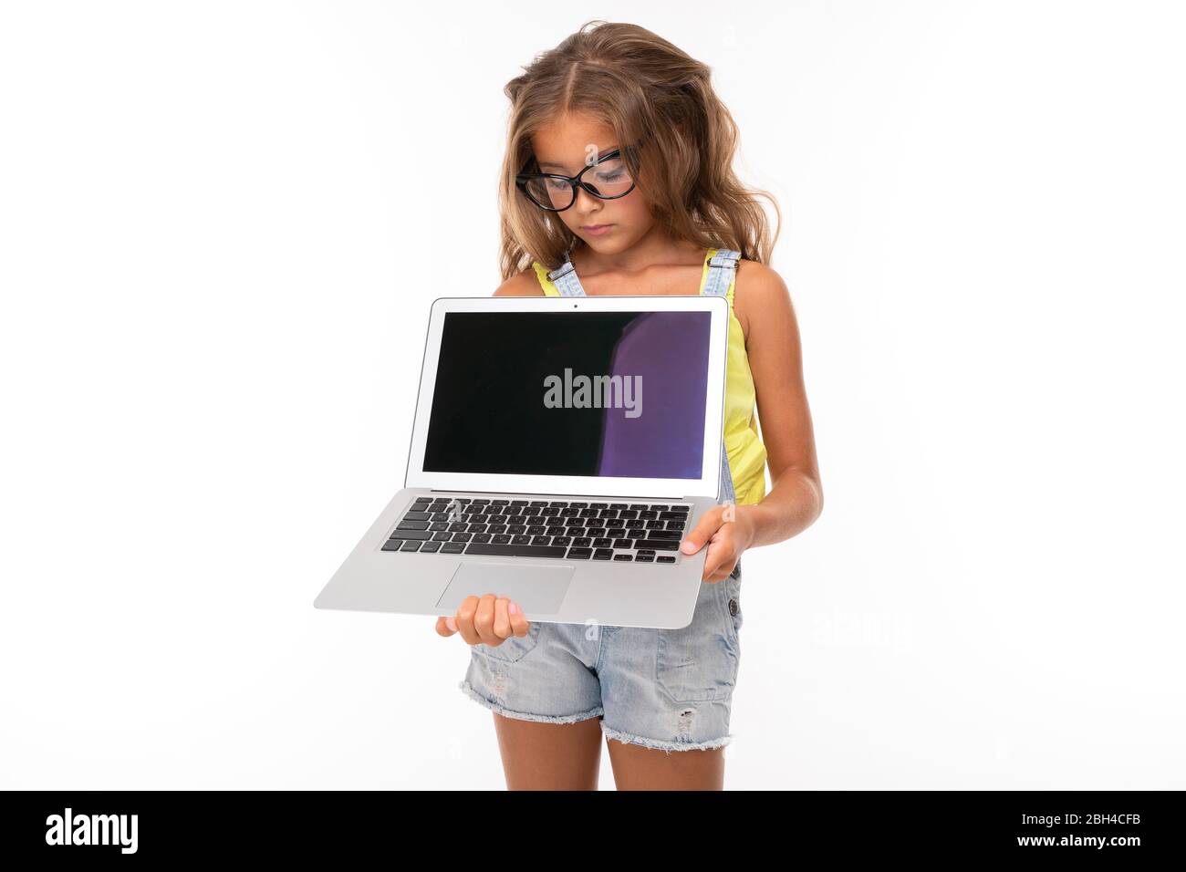 attractive european girl holding a computer in her hands with the ...