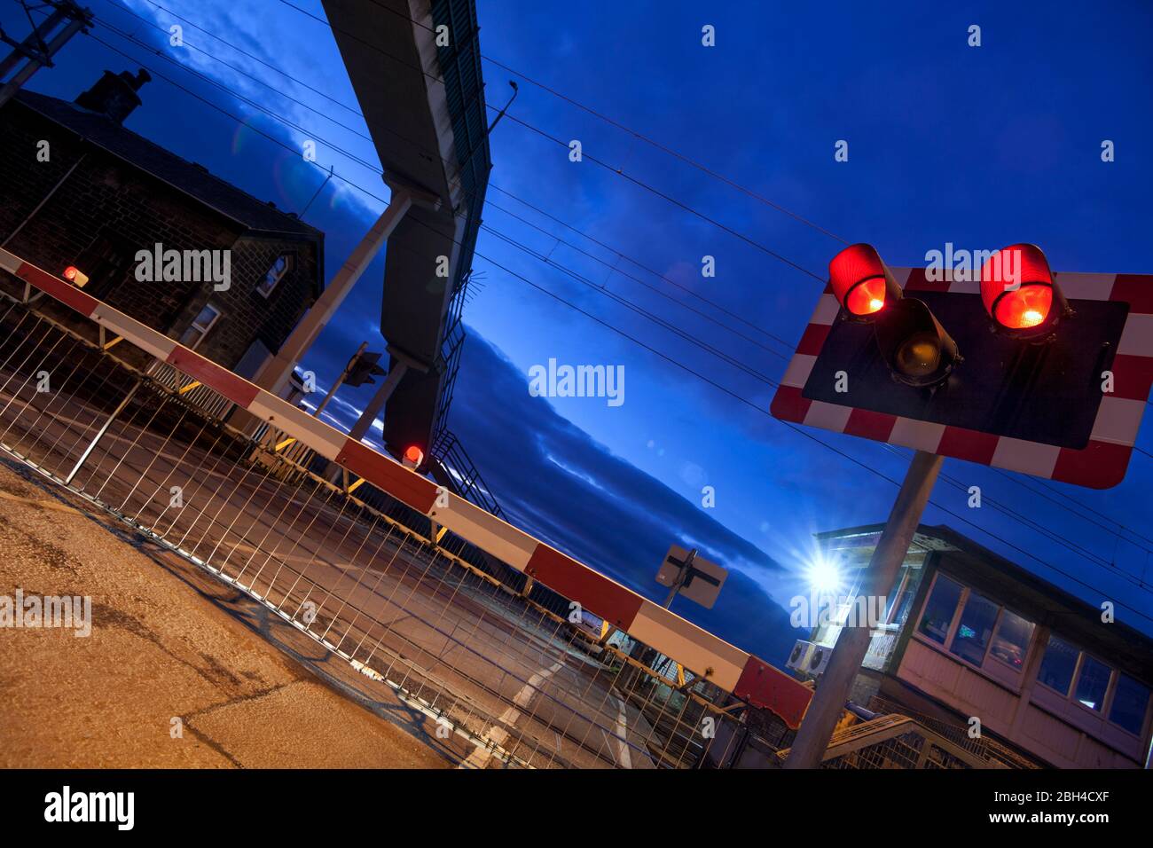 Red flashing lights, barriers and signal box at Hest Bank Level ...