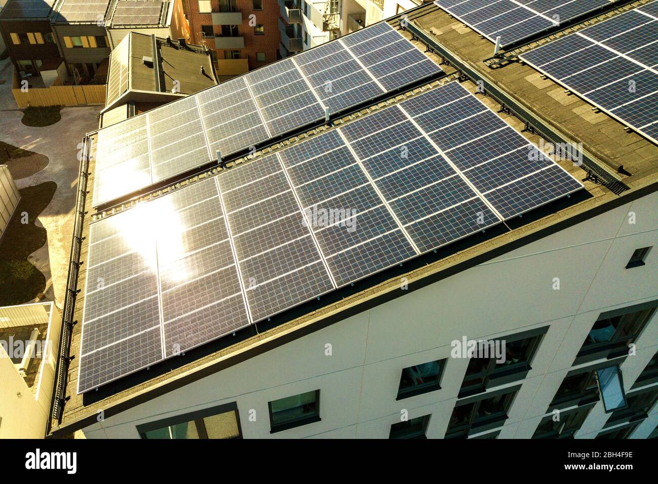 Aerial view of solar photovoltaic panels on a roof top of residential ...