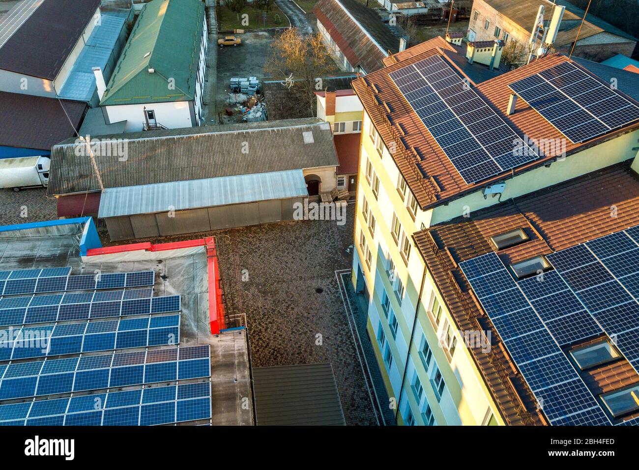 Aerial view of many photo voltaic solar panels mounted of industrial ...