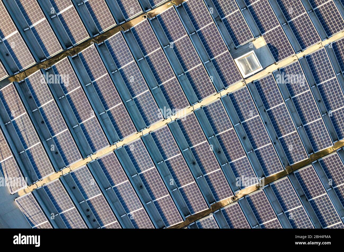 Aerial view of many photo voltaic solar panels mounted of industrial ...