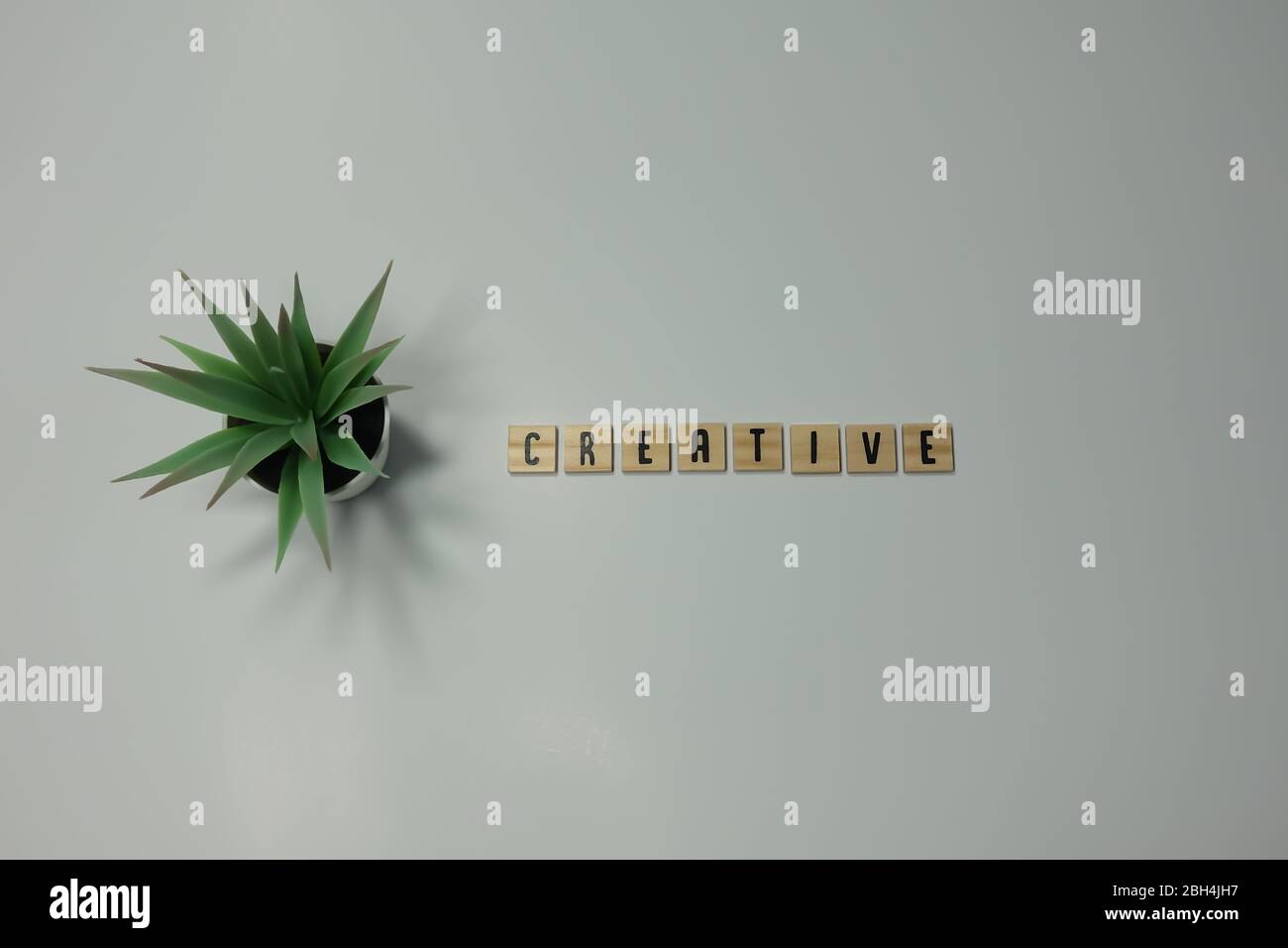 The word Creative spelled in wooden letter tiles in stop motion ...