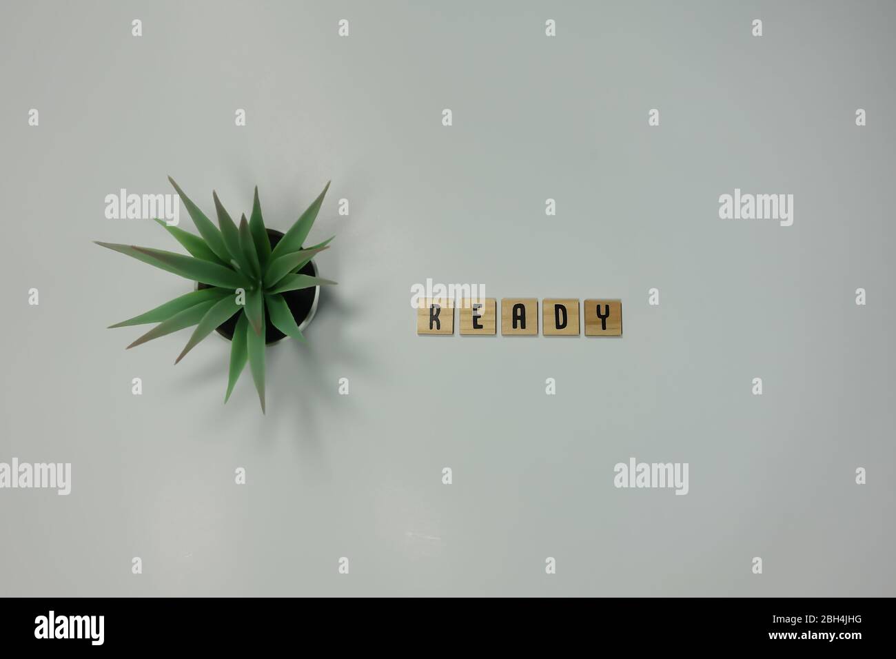 The word ready written in wooden letter tiles on a white background ...