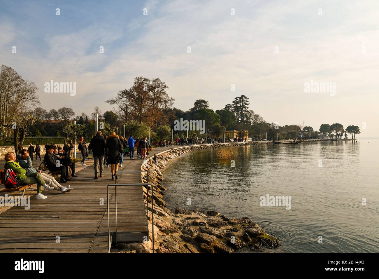 People walking relaxing water clouds benches hi-res stock photography ...