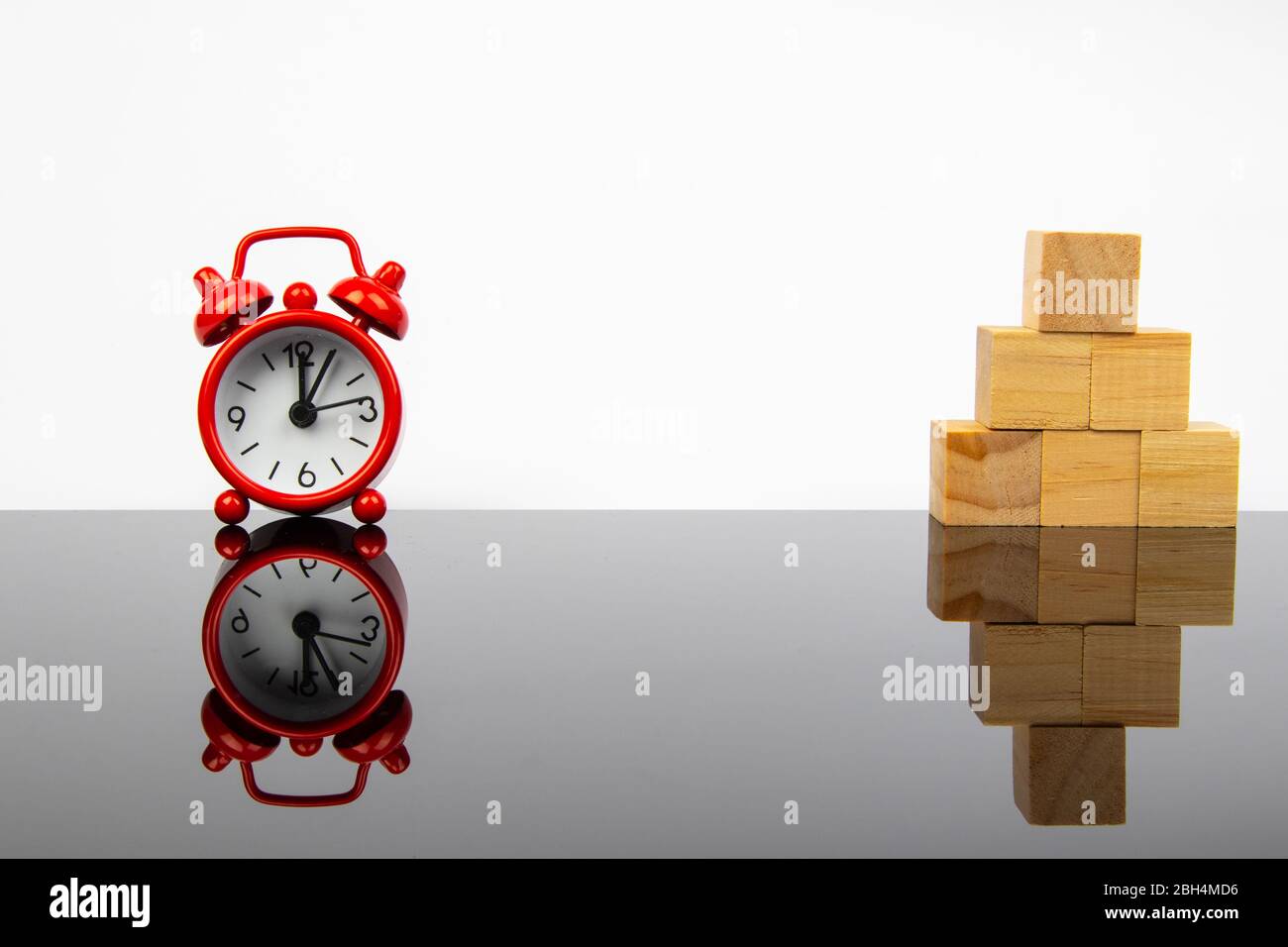 Red alarm clock and wooden cube block with leadership concept Stock ...