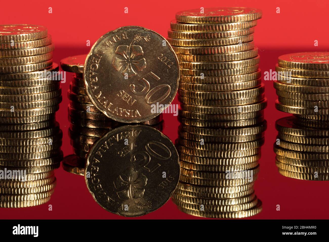 Close-up Malaysian ringgit coins with red background and reflection ...