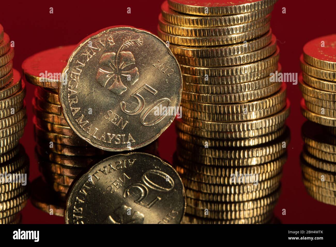 Close-up Malaysian ringgit coins with red background and reflection ...