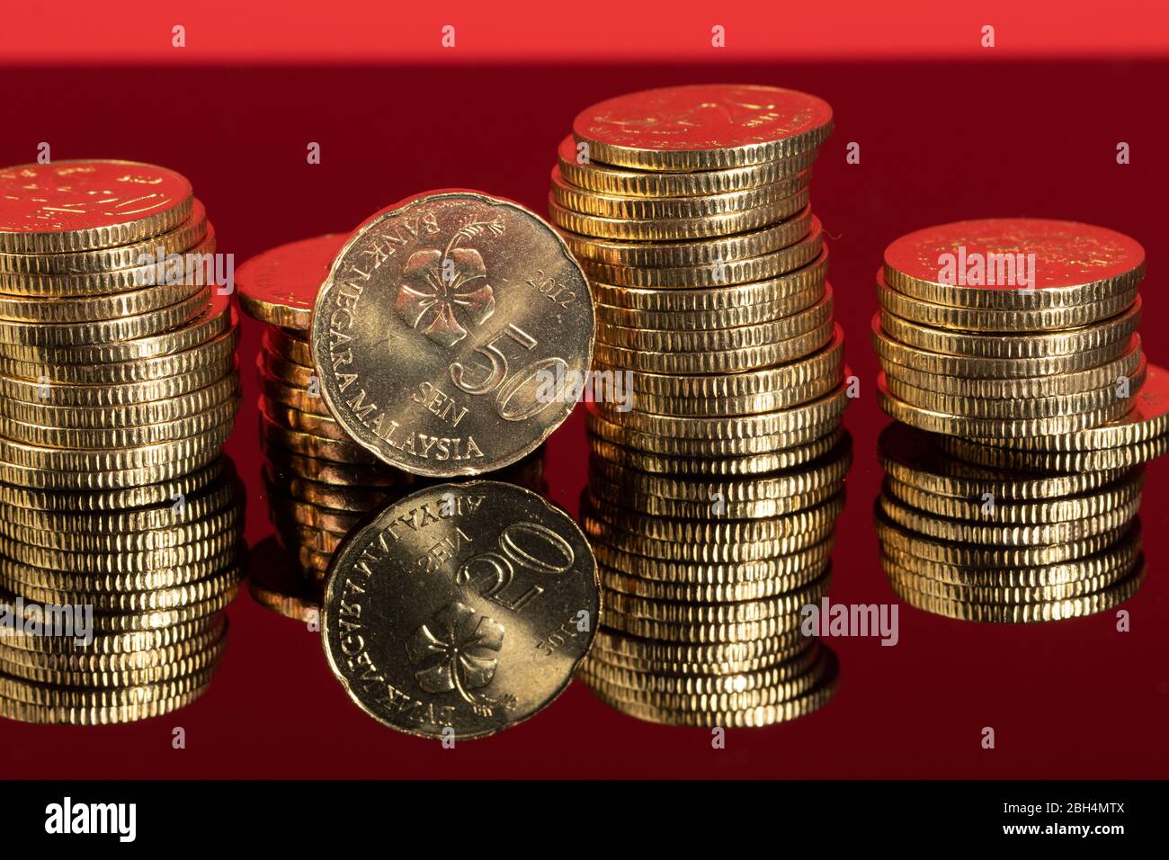 Close-up Malaysian ringgit coins with red background and reflection ...