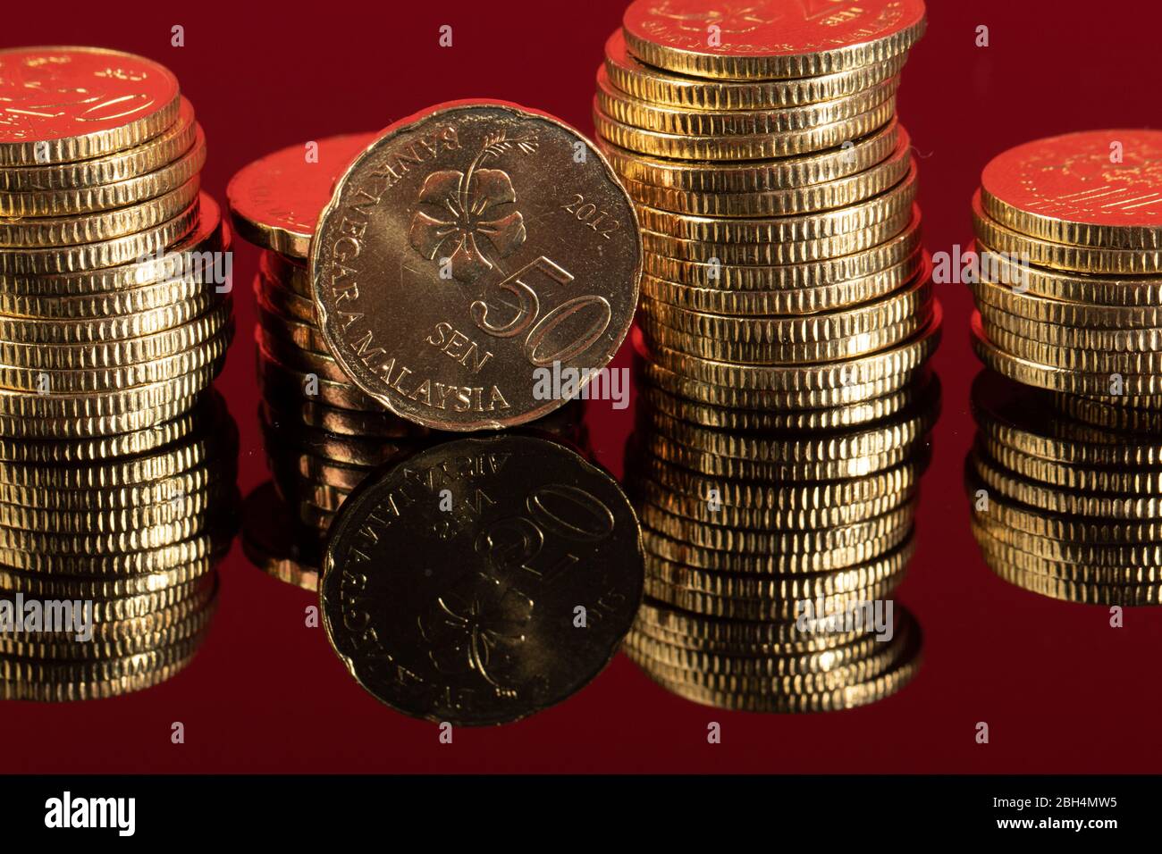Close-up Malaysian ringgit coins with red background and reflection ...