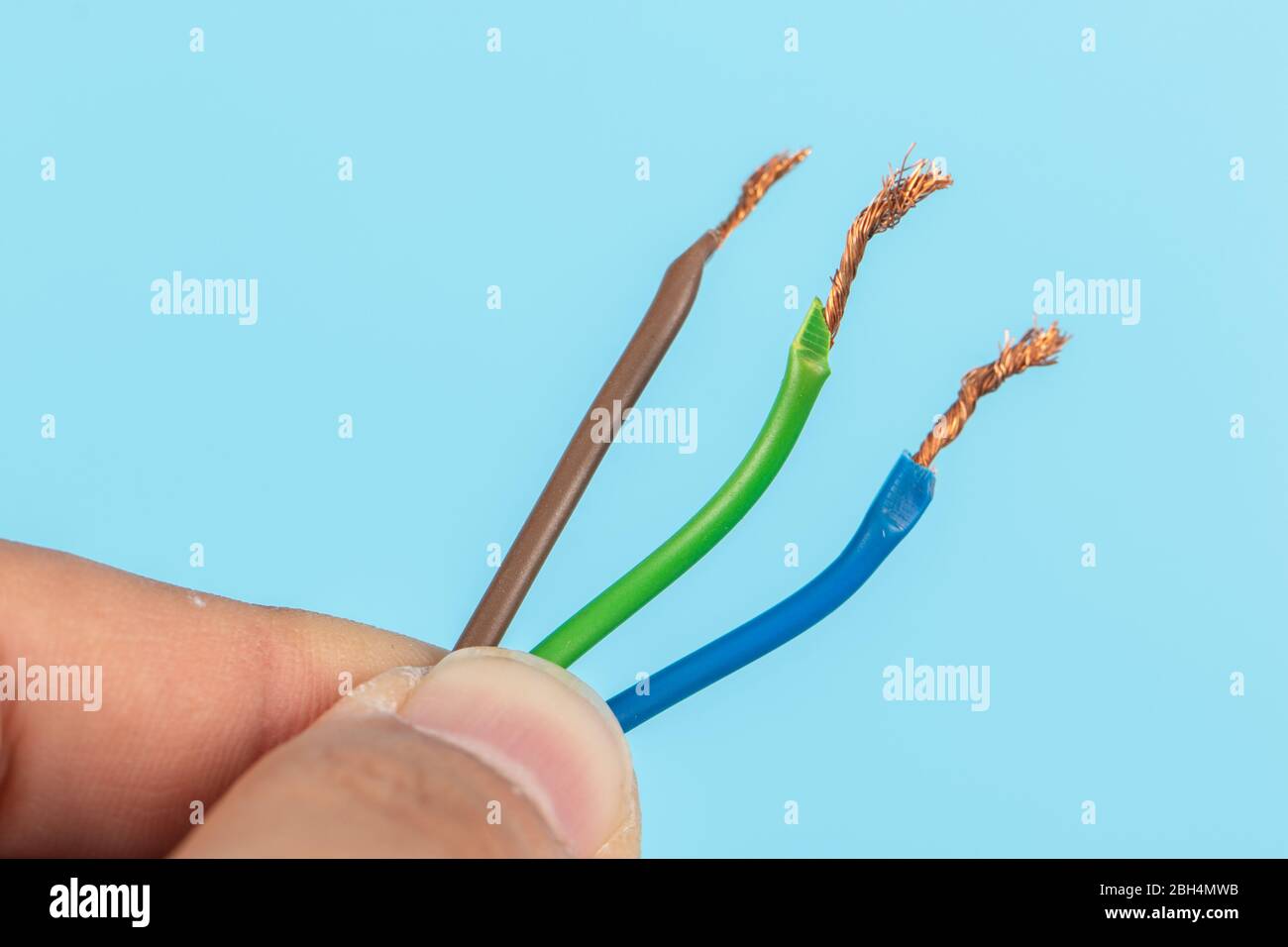 Electric wire isolate on blue background Stock Photo - Alamy