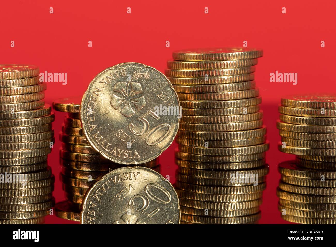 Close-up Malaysian ringgit coins with red background and reflection ...