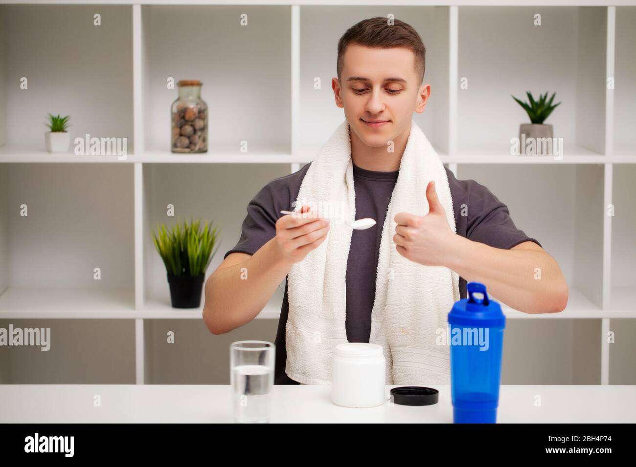 Man prepares a protein shake in the shaker after training Stock Photo ...