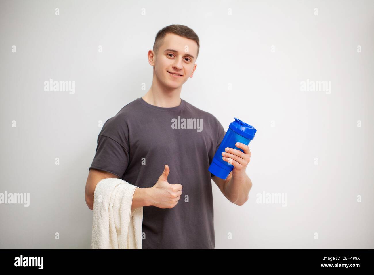 Man prepares a protein shake in the shaker after training Stock Photo ...