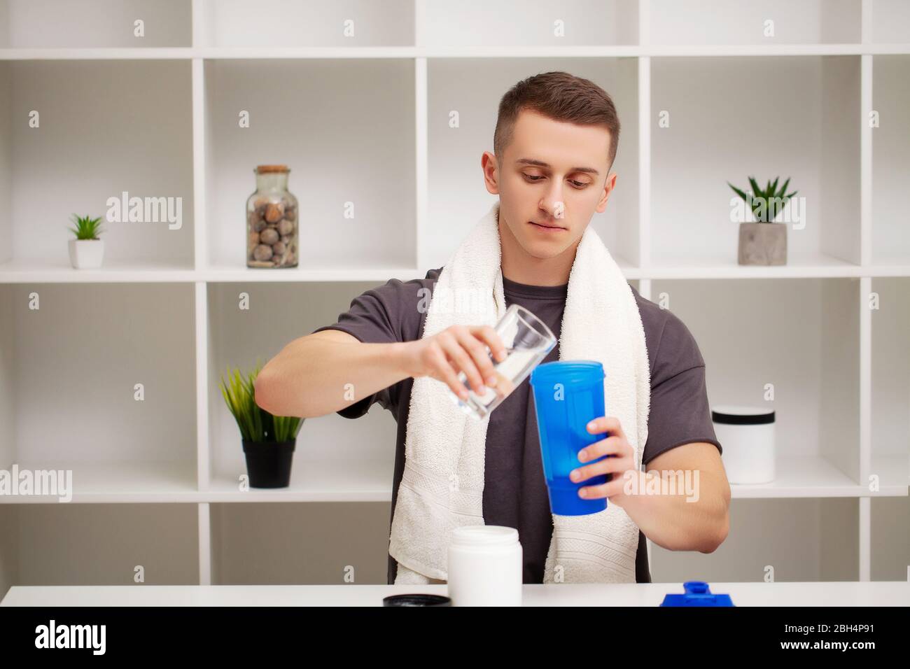 Man prepares a protein shake in the shaker after training Stock Photo ...