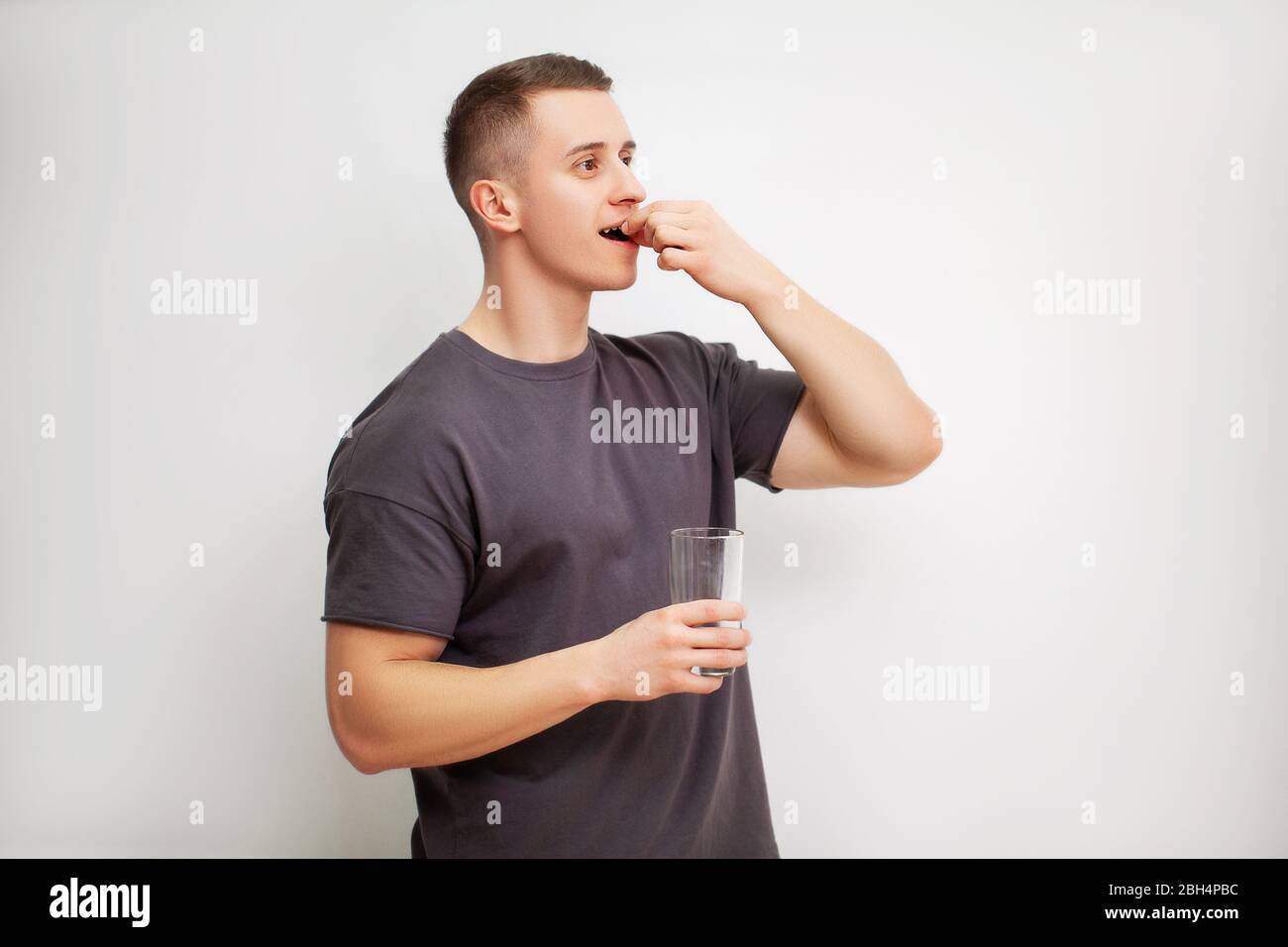 man-takes-a-pill-of-amino-acids-after-training-stock-photo-alamy