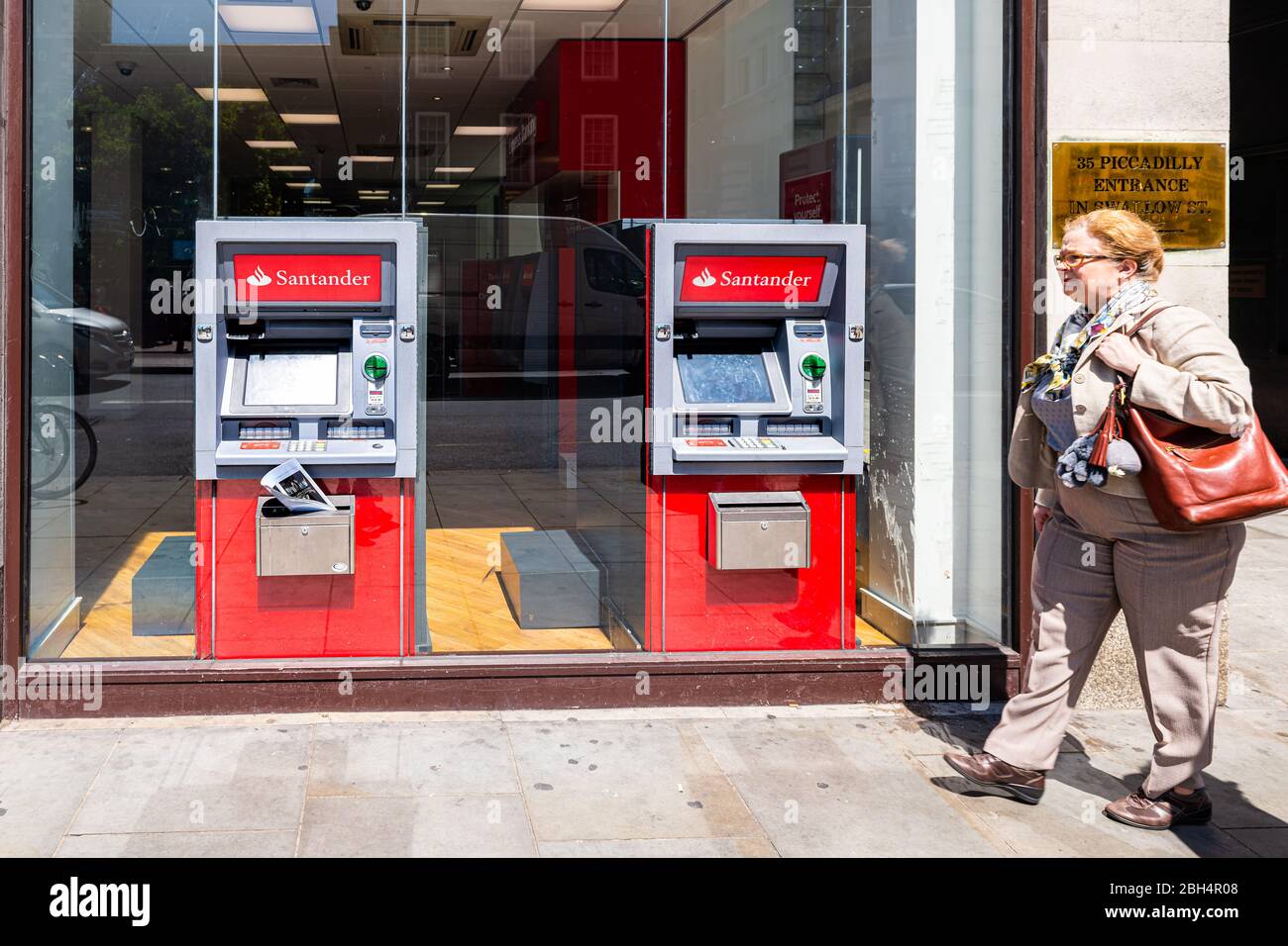 London, UK - June 22, 2018: Red Santander bank cash sign atm with ...
