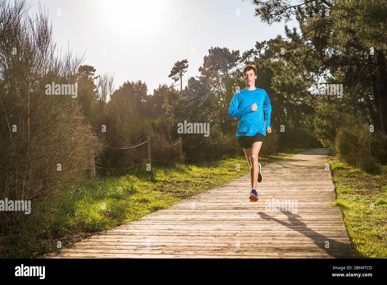 Athletic young man running in the nature. Healthy lifestyle Stock Photo ...