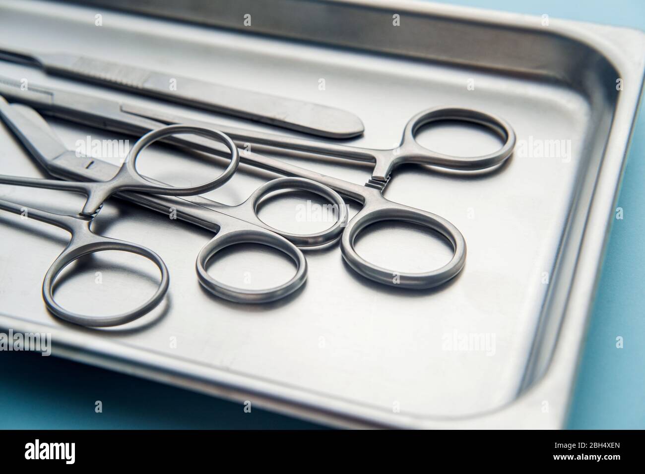Forceps and scalpel on tray Stock Photo - Alamy