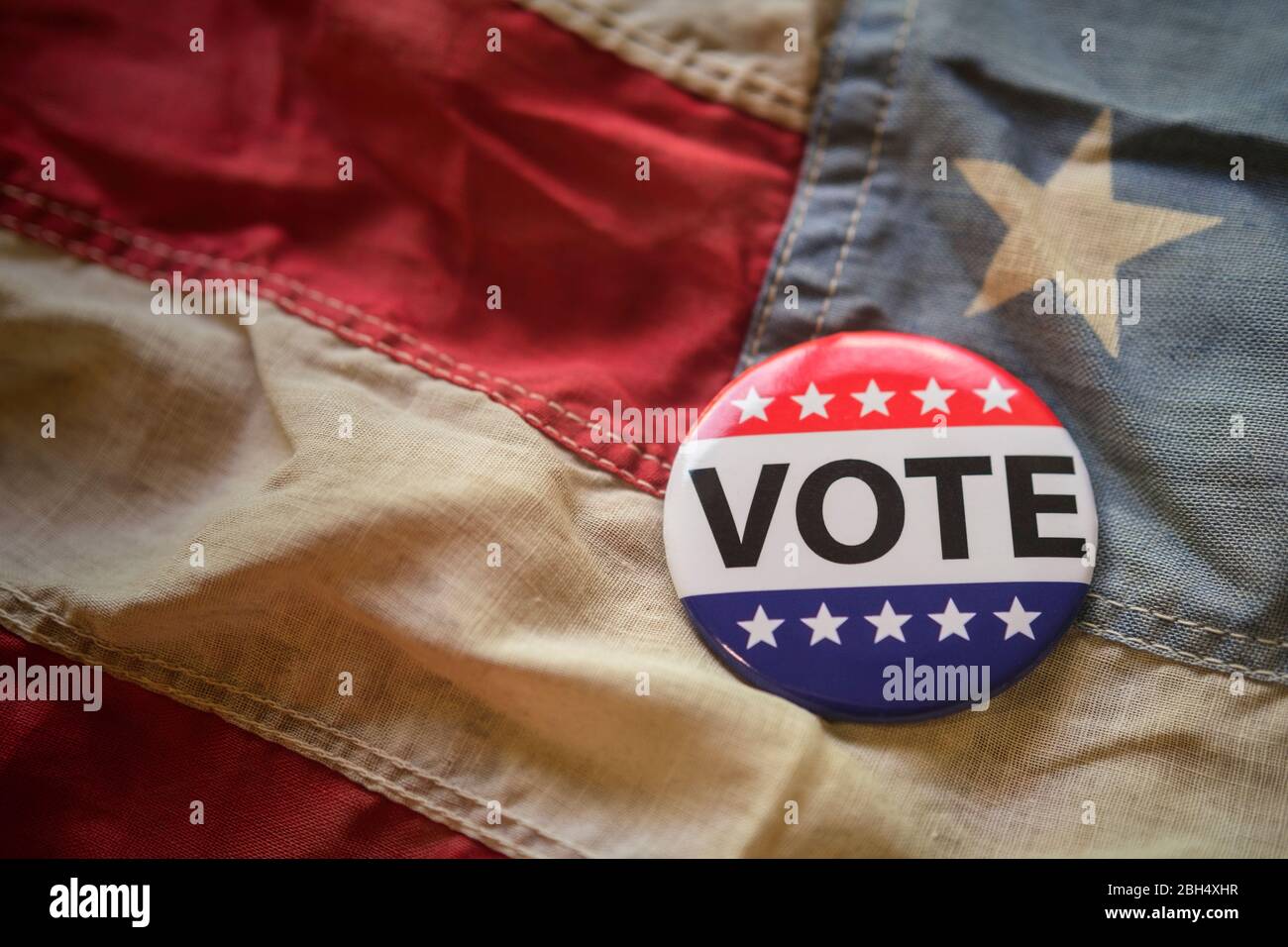 Vote button on American flag Stock Photo - Alamy