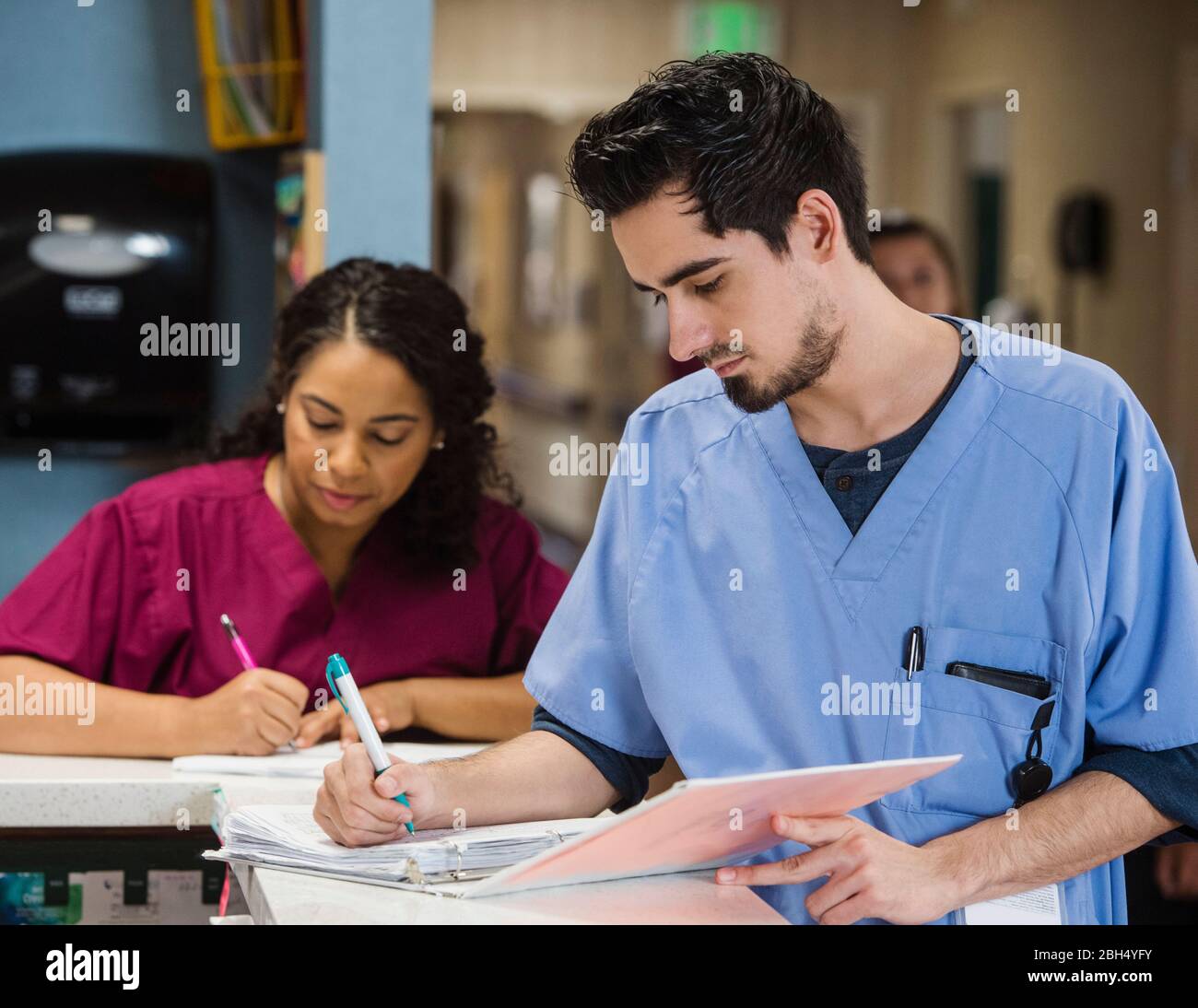 Nurses doing paperwork Stock Photo - Alamy