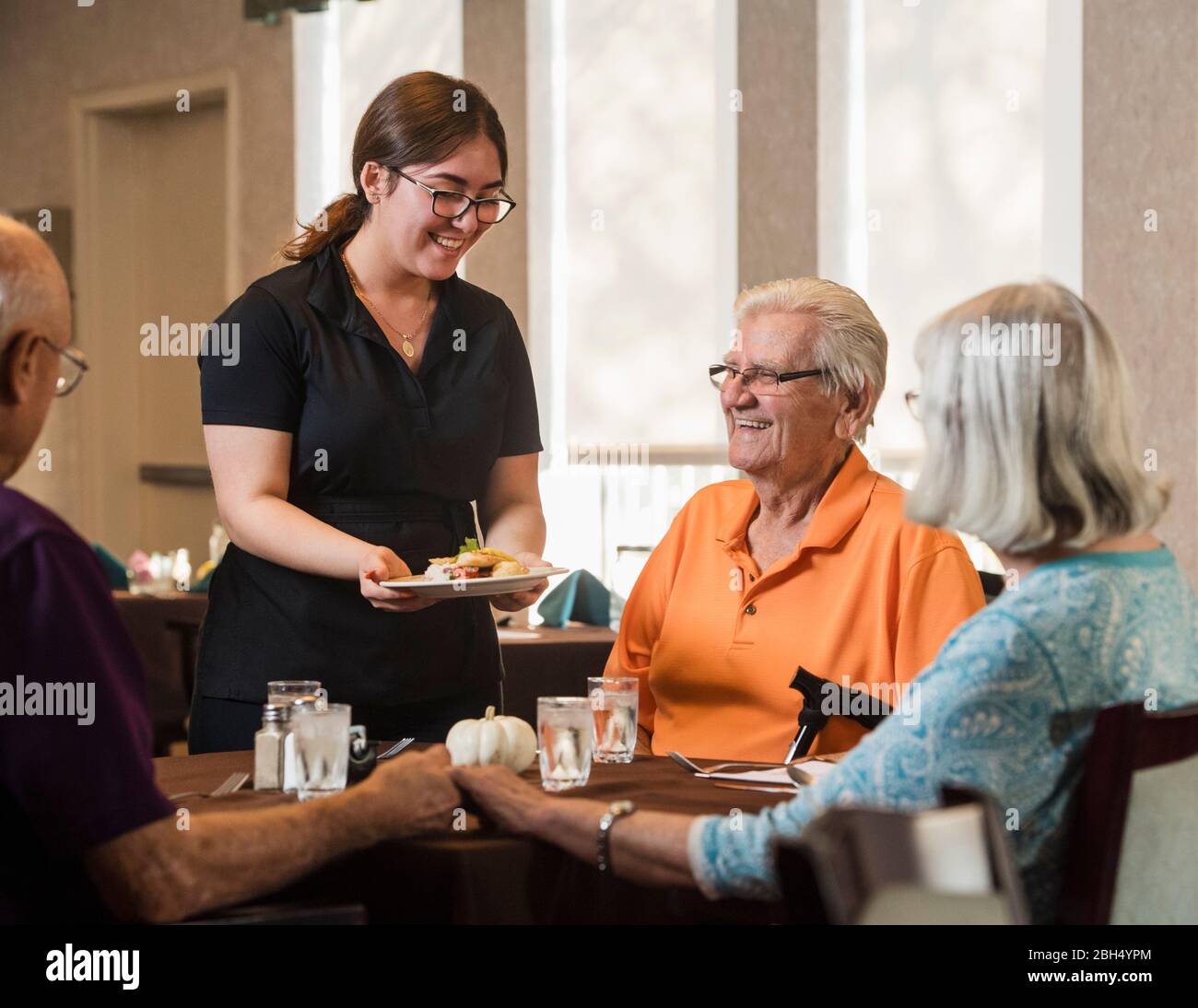 Four women handing hi-res stock photography and images - Alamy