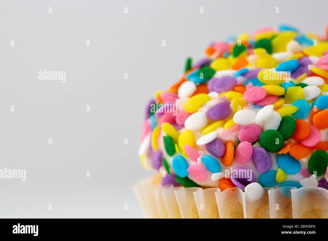 Cupcake with colorful sprinkles Stock Photo - Alamy