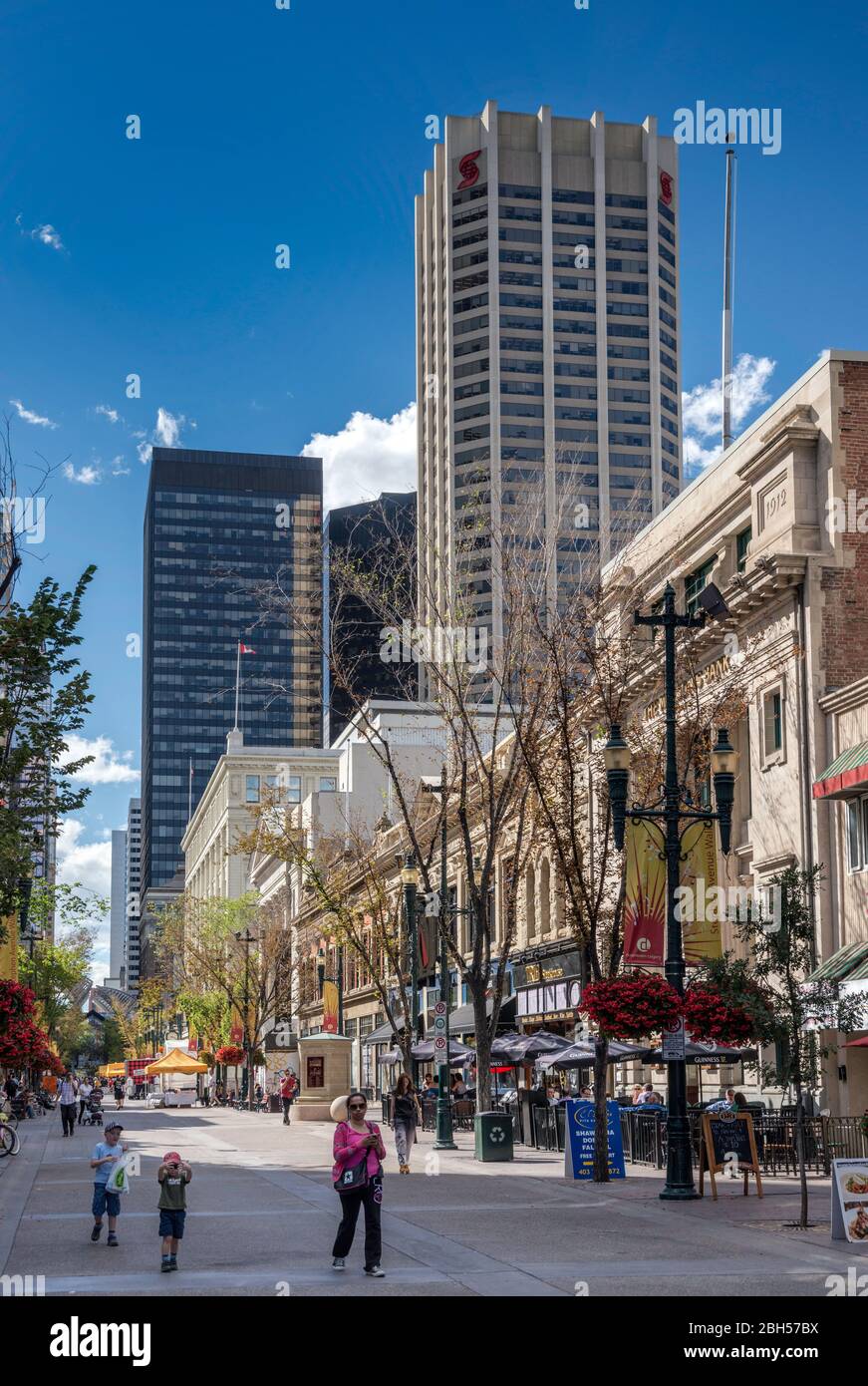 Office towers over historical buildings on Stephen Avenue in downtown ...
