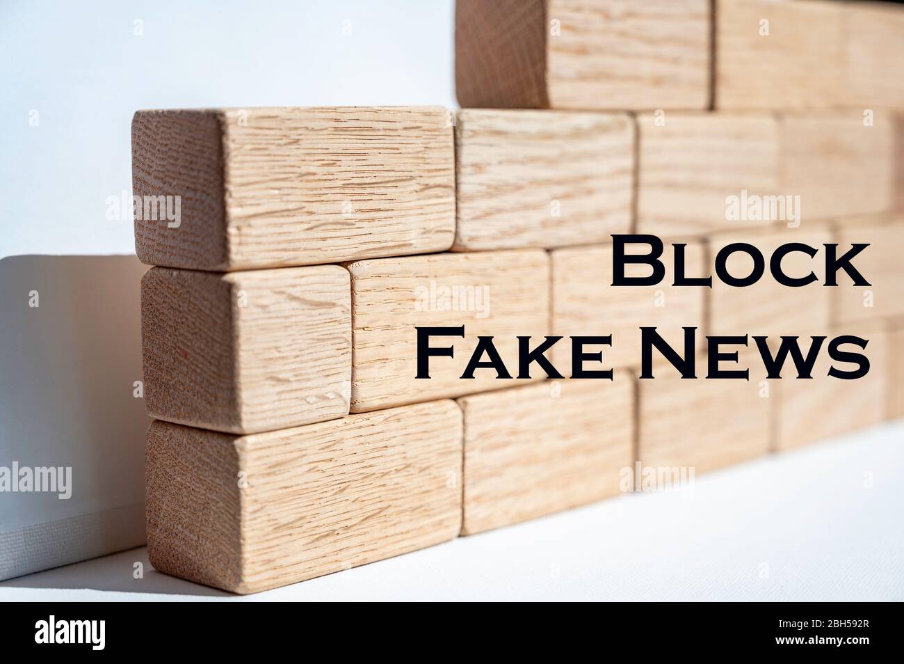 Wooden building blocks forming a wall as a concept to "Block Fake News ...
