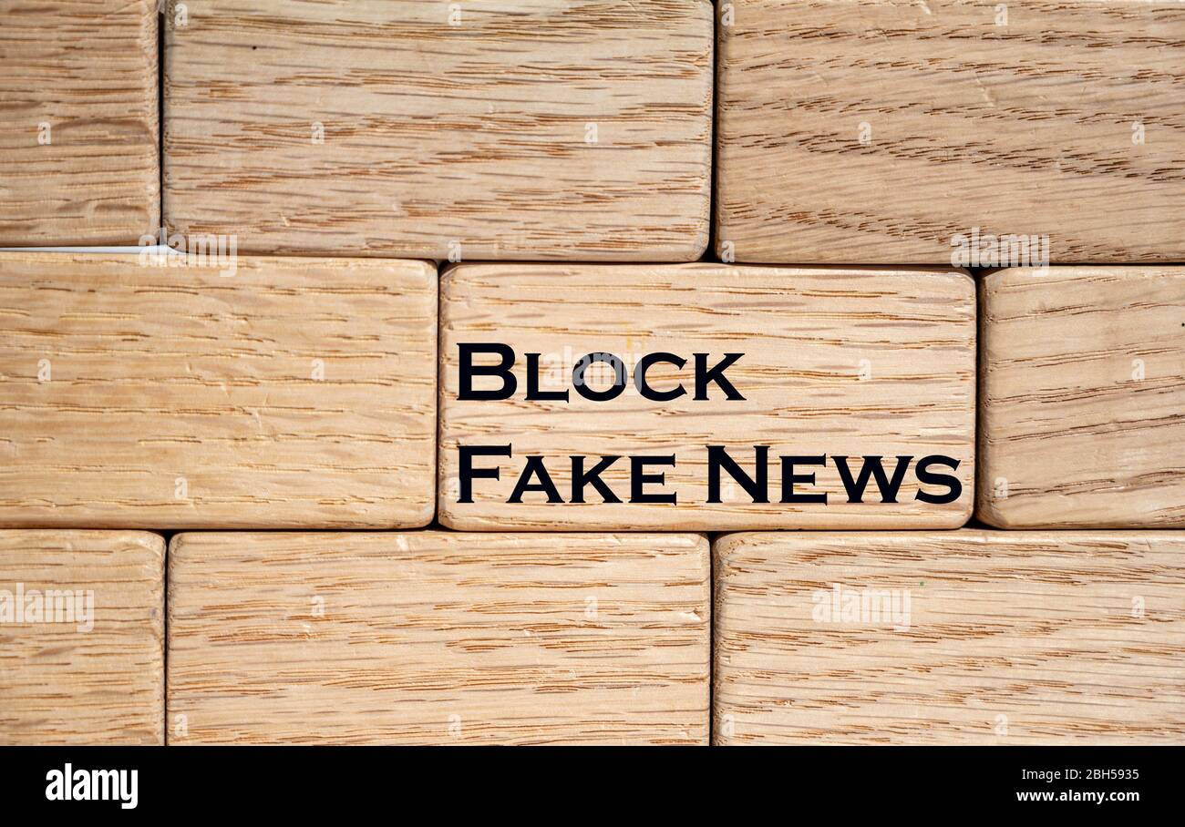 Wooden building blocks forming a wall as a concept to "Block Fake News ...