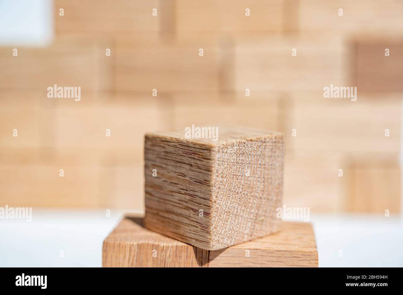Wooden block cubes stacked in a pyramid in front of a defocused block ...