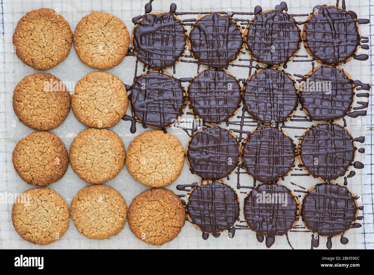 Homemade dark chocolate covered hobnob biscuits on a wire rack Stock ...