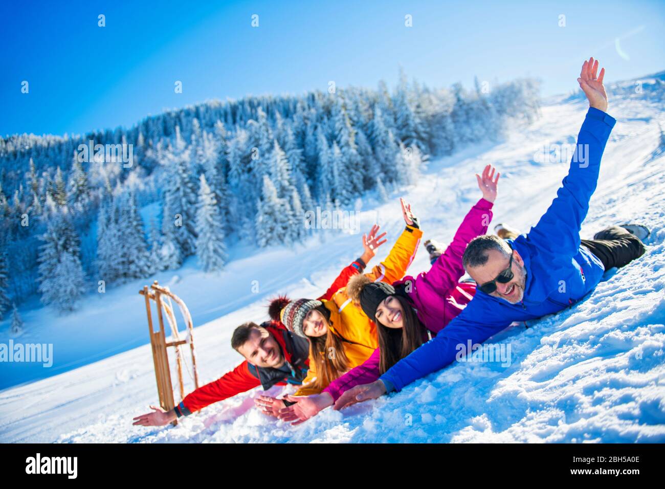 Friends Have Fun At Winter On Fresh Snow Stock Photo - Alamy