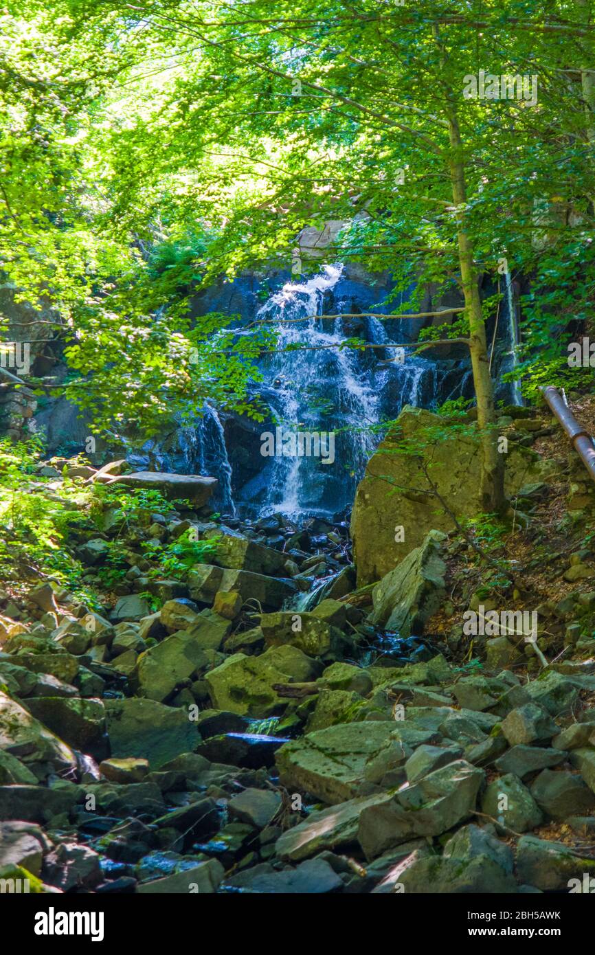 mountain stream waterfall with pure and clear water that runs fast ...