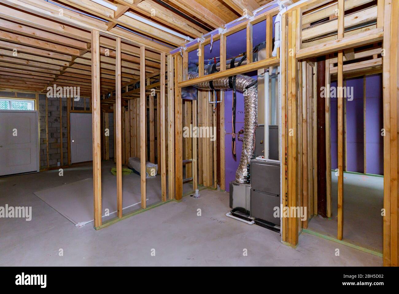 Interior view of a basement under construction home framing with beam ...