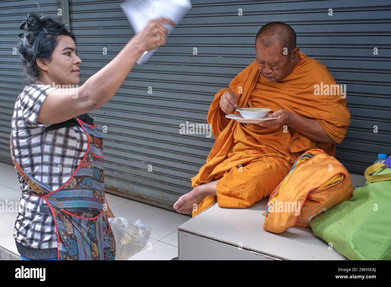 During the Covid-19 outbreak in Bangkok, Thailand, a Buddhist monk eats ...