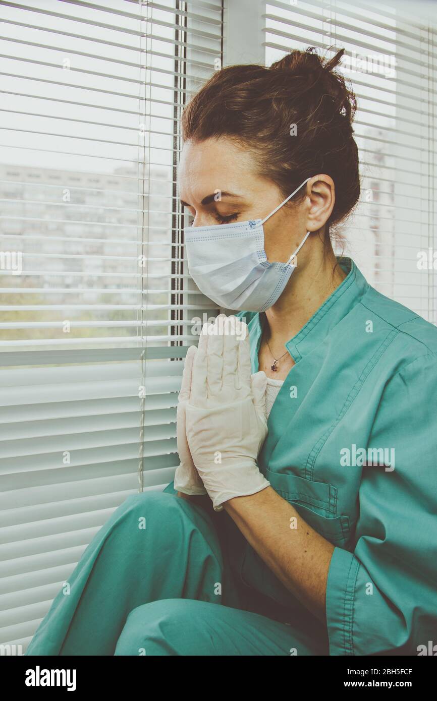 Tired exhausted doctor with medical surgical mask on her Face, doctor's ...