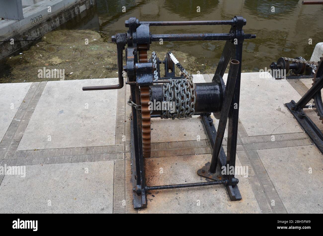 metal chain on hand crank reel or spool and water Stock Photo - Alamy