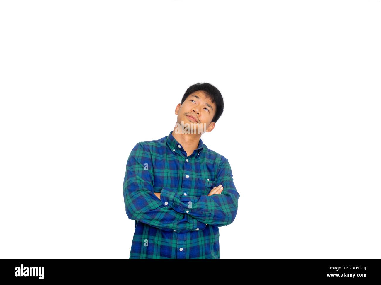 The Asian untidy man in blue plaid shirt is crossing his arms and ...