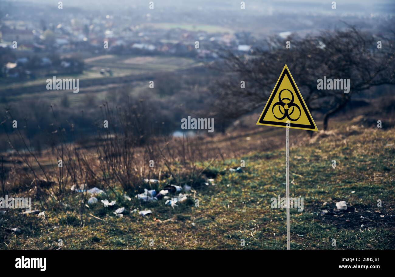 Yellow biohazard sign installed in ecologically problematic polluted ...