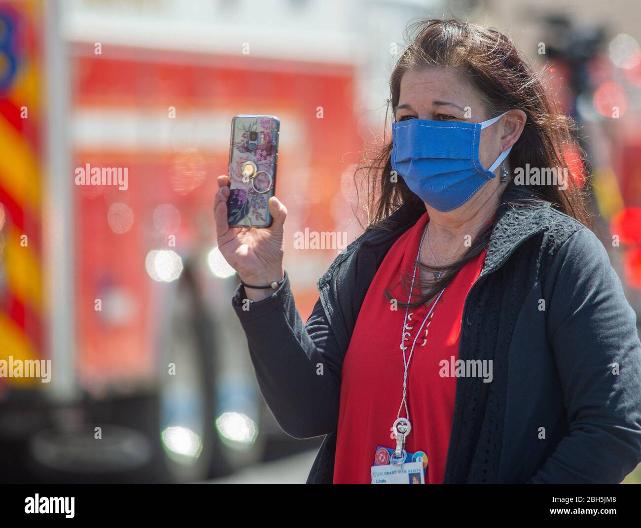 Linda Spier records a video of fire, police and ambulance services from ...