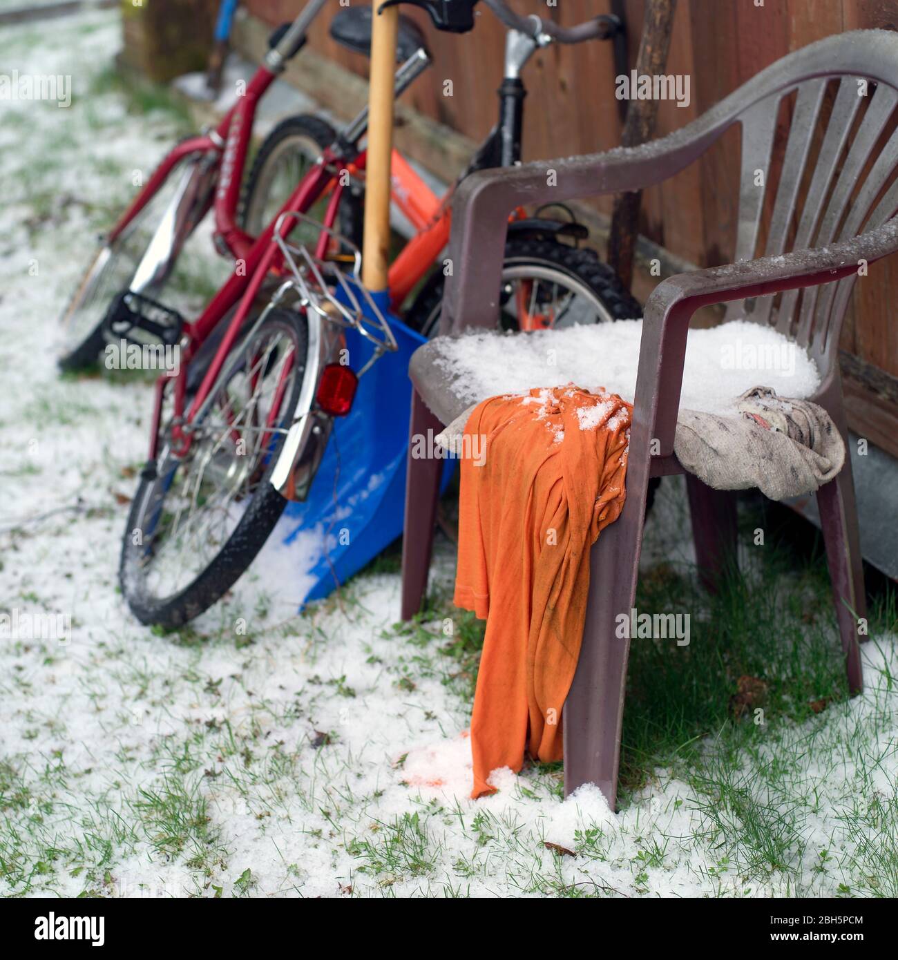 Collection of household objects abandoned under snow, outdoor shot ...