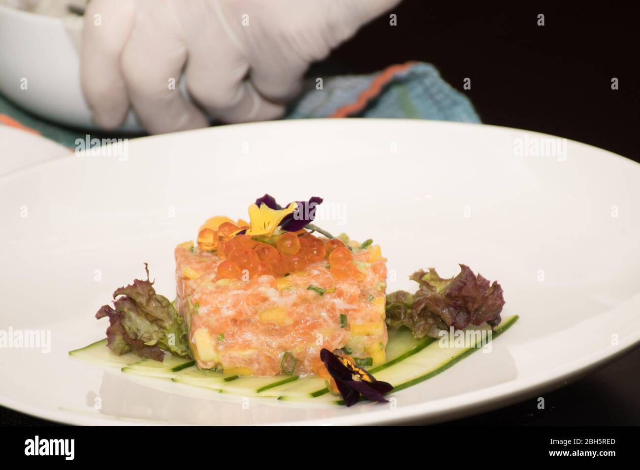 Chef with white hand gloves preparing food during brunch buffet Stock ...