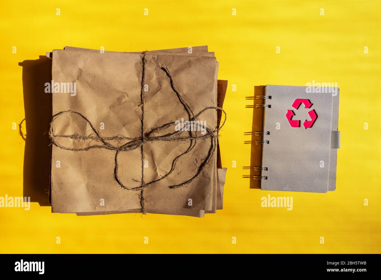 Concept of waste paper recycling process. Note book made of reusable ...