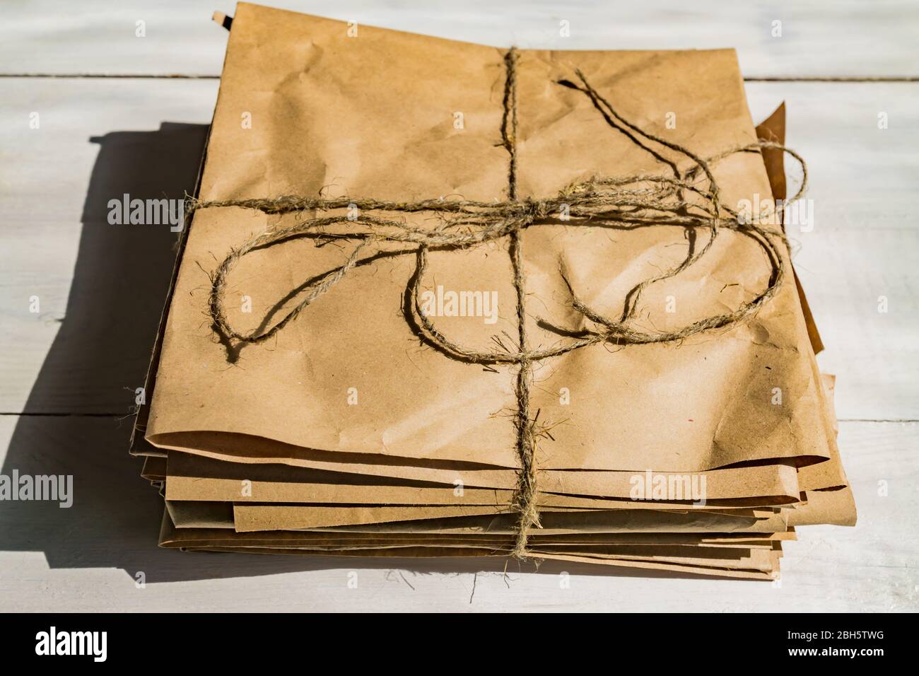 close up of stucked wrapping paper ready for recycling on white wooden ...
