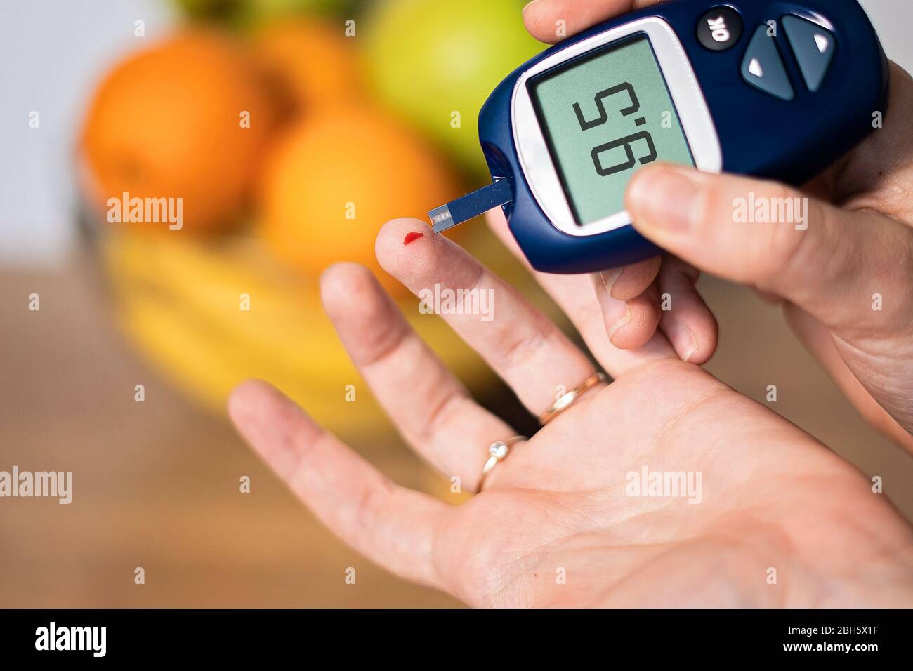 Close up of hand metering glucose in blood at home Stock Photo - Alamy