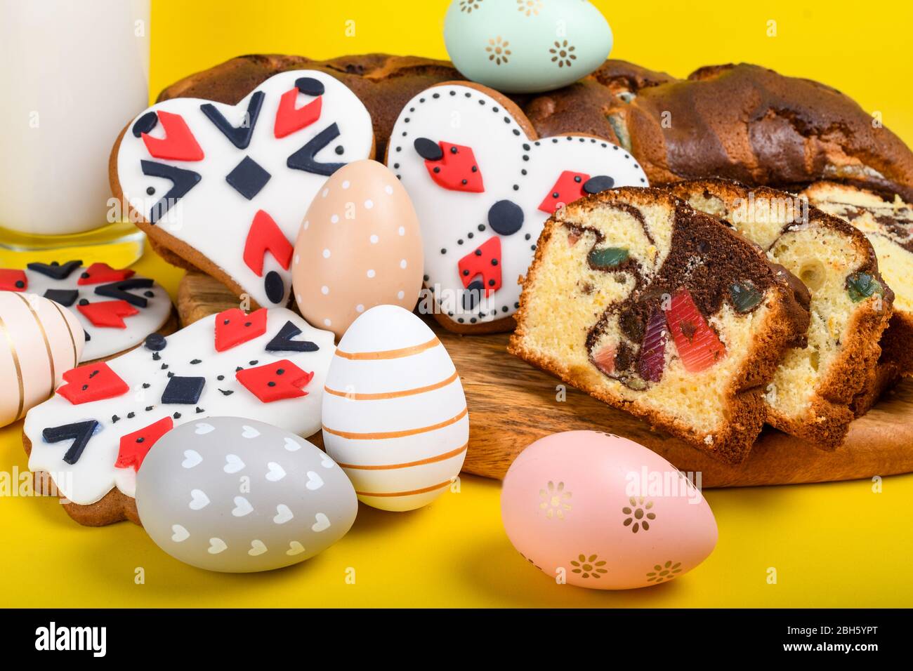 Slices of Romanian sponge cake with red traditional towel with manual ...